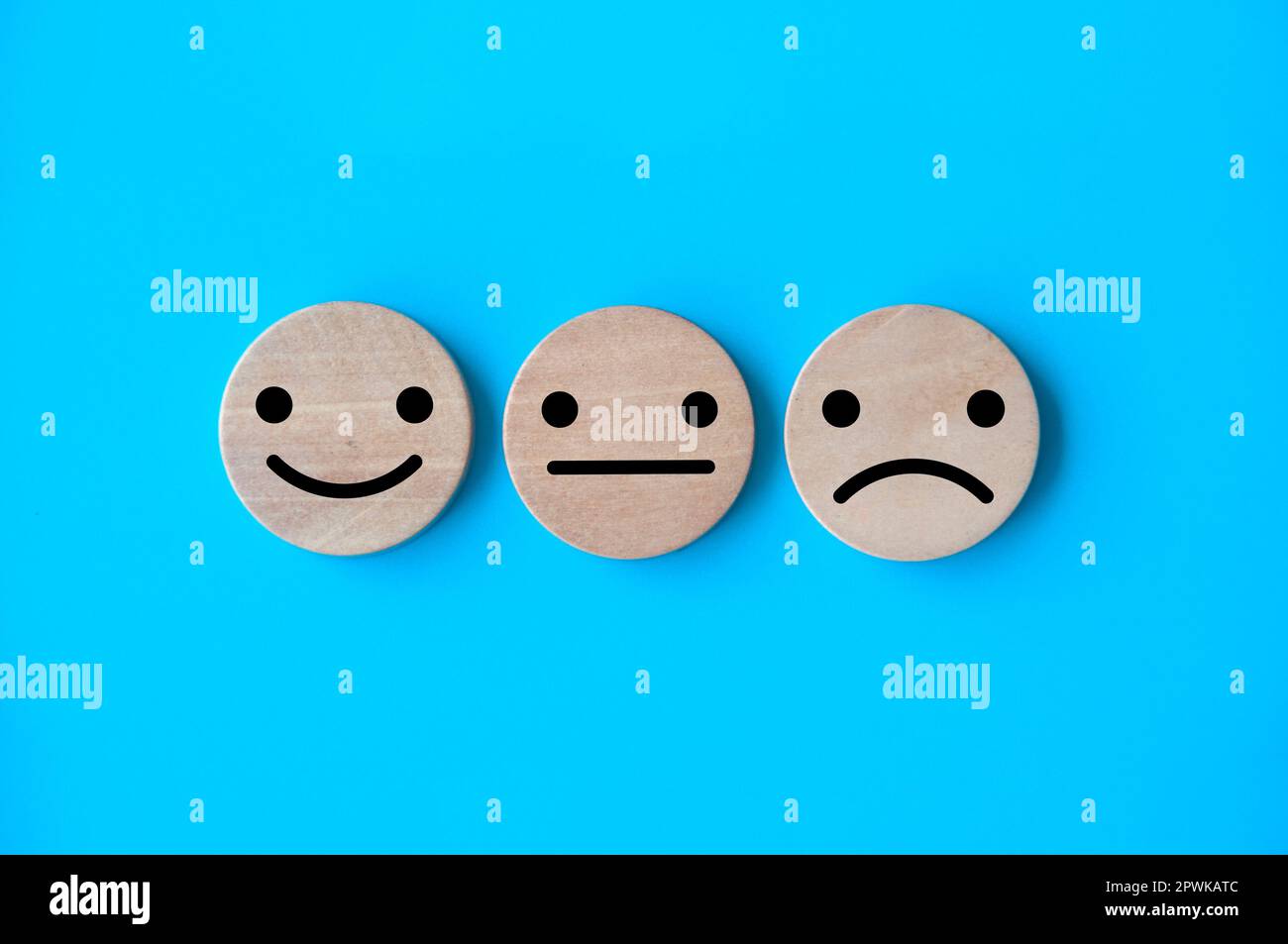 Happy, neutral, and sad emotion faces on wooden circle. Customer ...