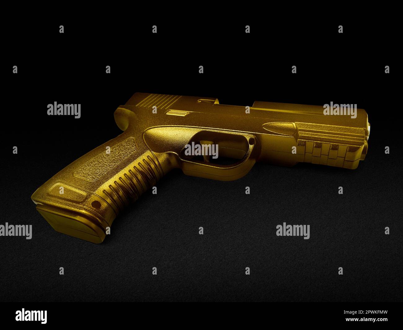 gun gold metal isolated on black background Stock Photo - Alamy