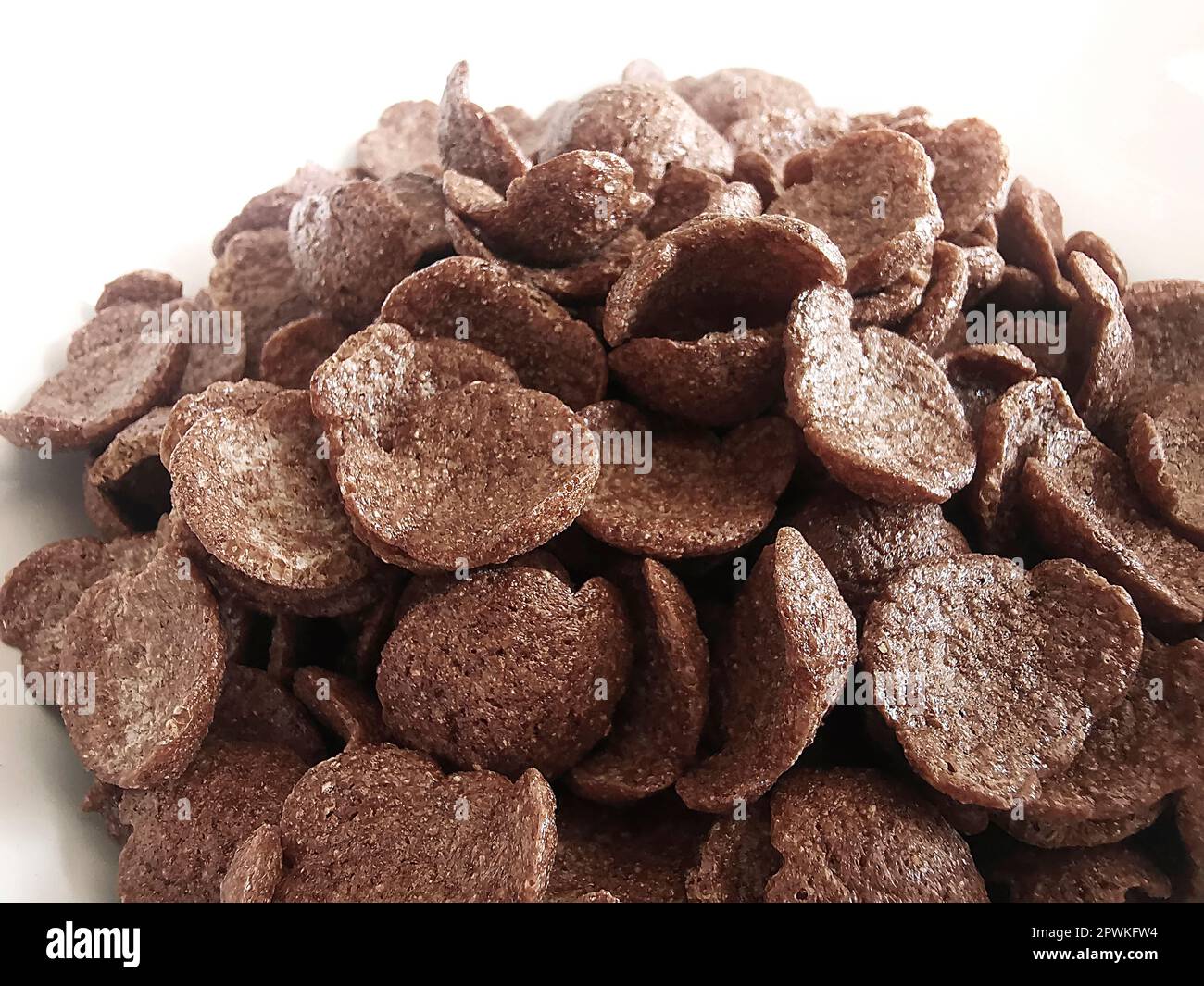 Chocolate corn flakes on the white background Stock Photo - Alamy