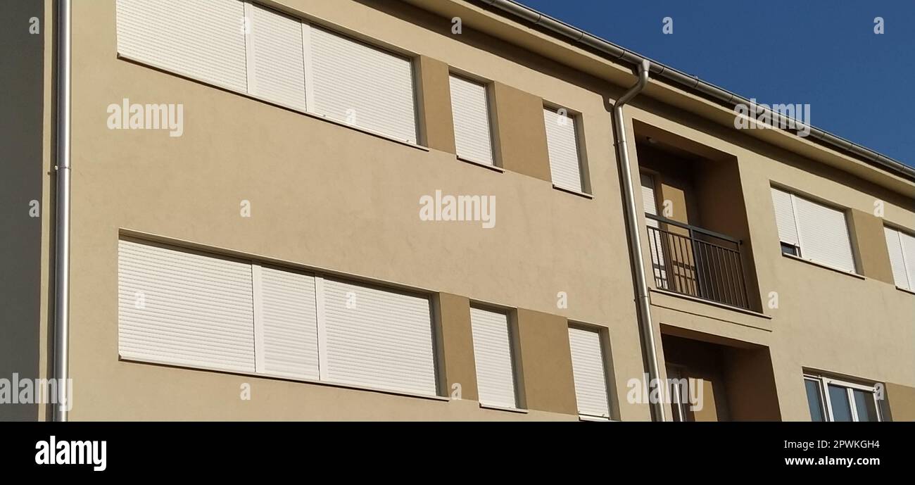 Facade of a new residential building. Modern buildings. Plaster beige ...