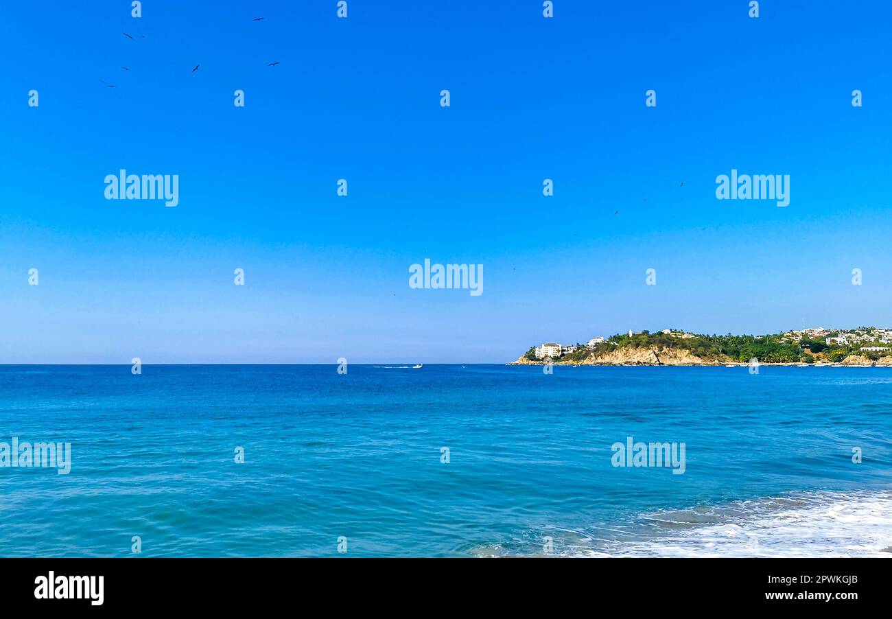 Beach sand blue water rocks cliffs and huge big surfer waves on the ...