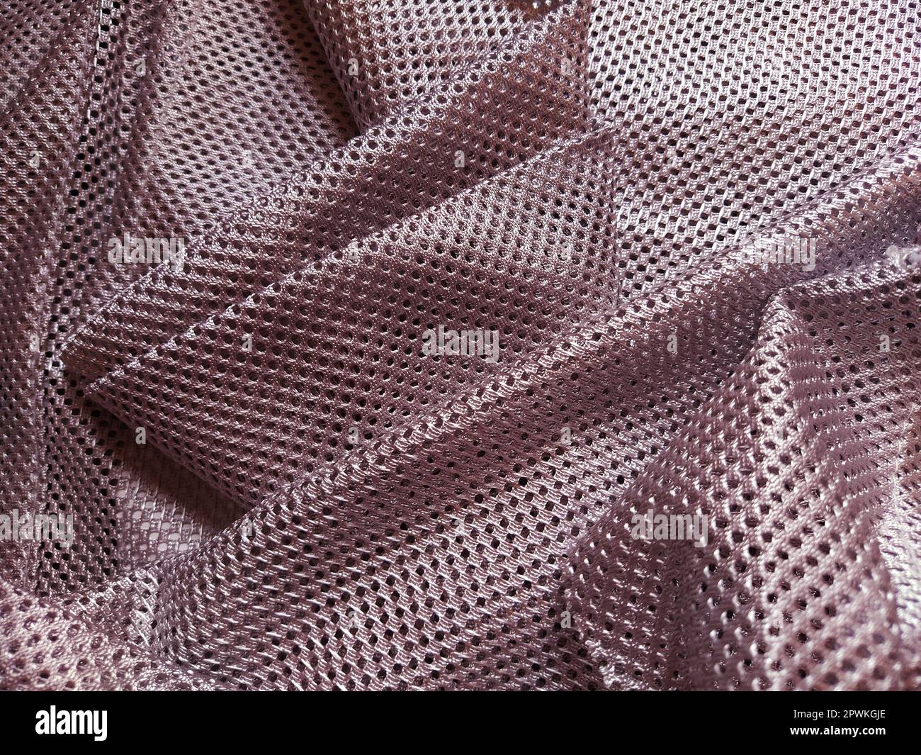 Synthetic polyester fabric with holes. Abstract background. Wave-folded ...