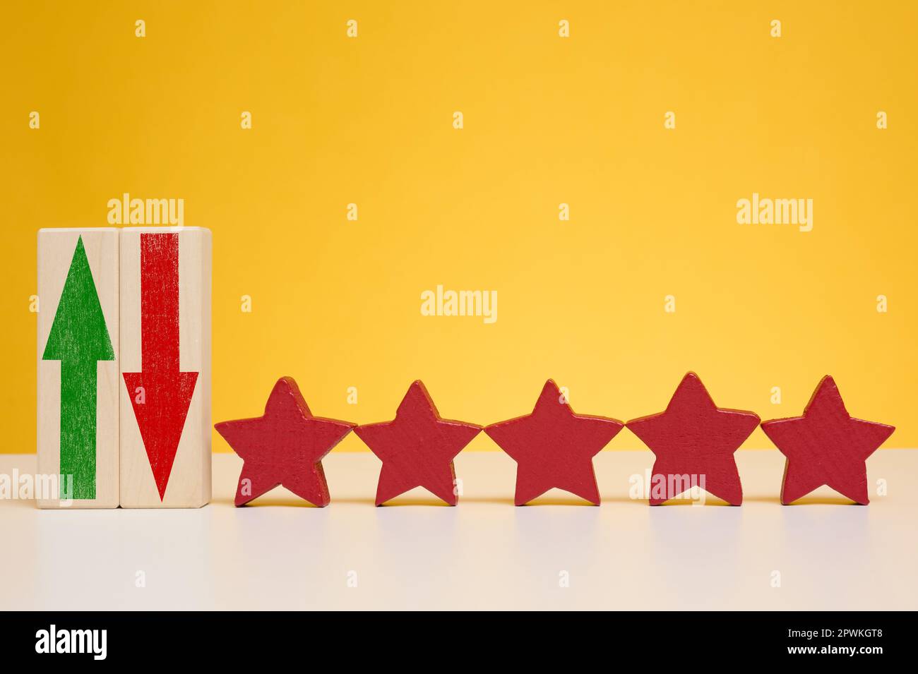Five stars on wooden cubes, yellow background. Service evaluation ...