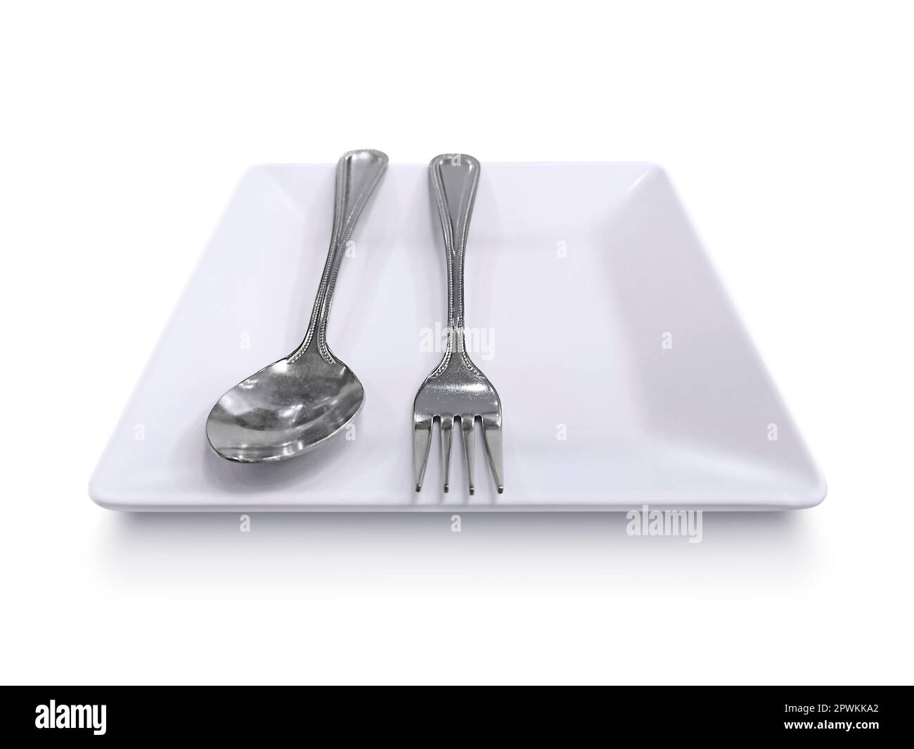 Spoon, fork and plate isolated on white background Stock Photo - Alamy