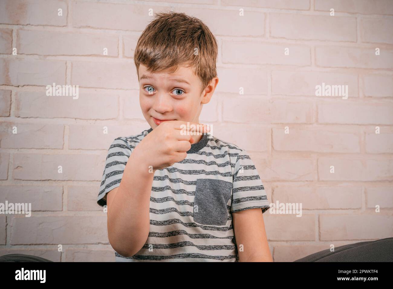 cute caucasian boy point index finger aside on area workspace Stock ...