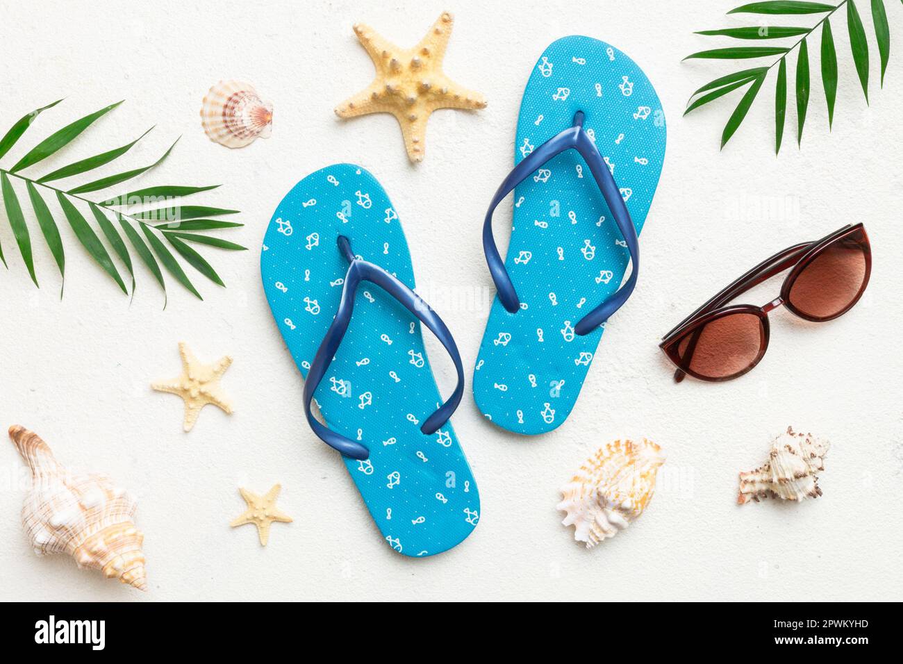 Summer travel concept. Flip flops, sunglasses and starfish on white ...