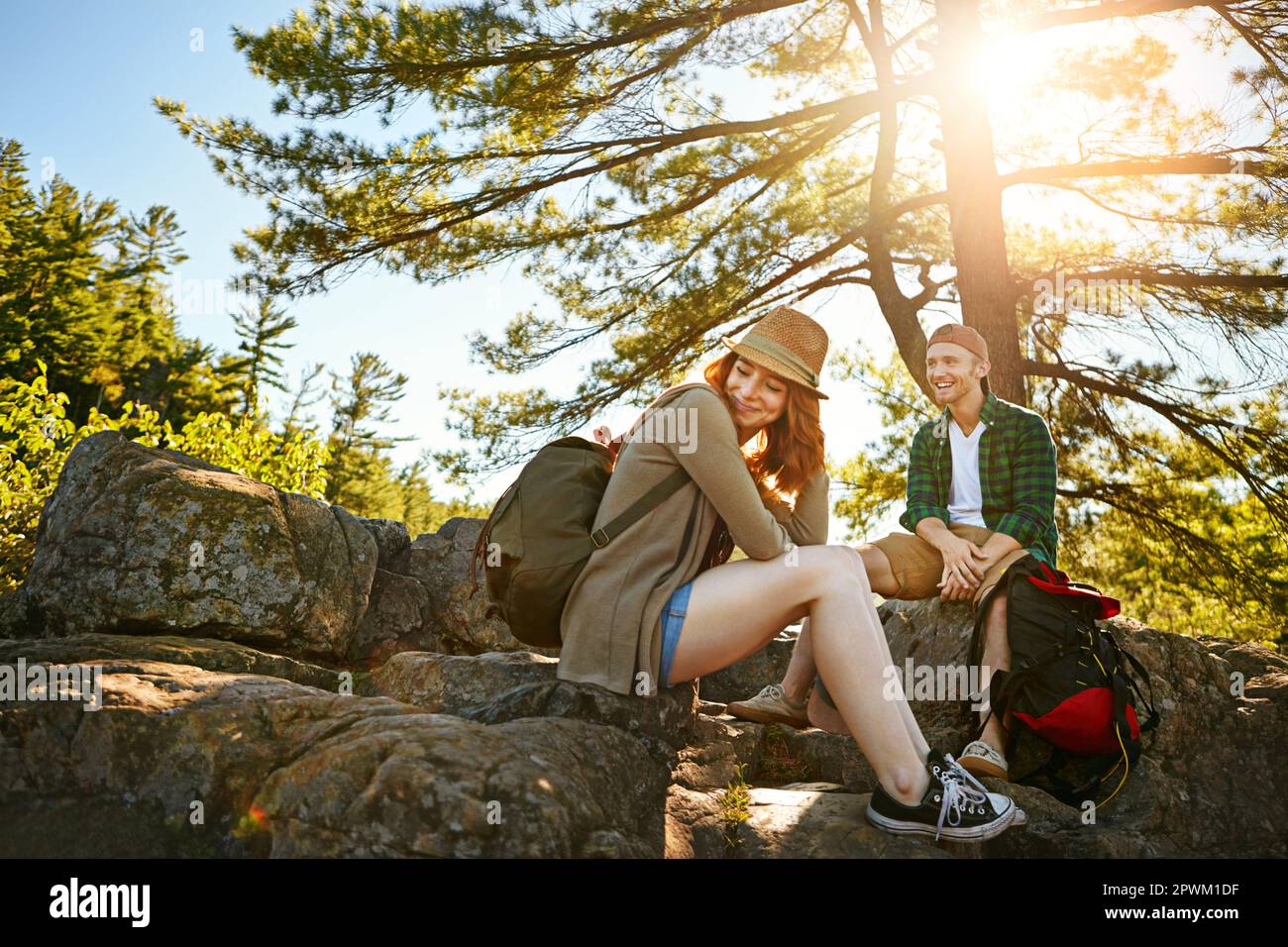 Exploring the country by foot. two young people hiking while on an ...