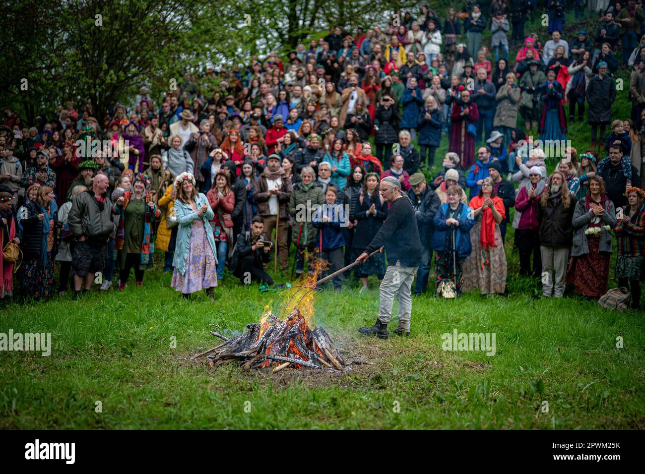 The bonfire is stoked as people watch the Beltane ceremony at Chalice ...