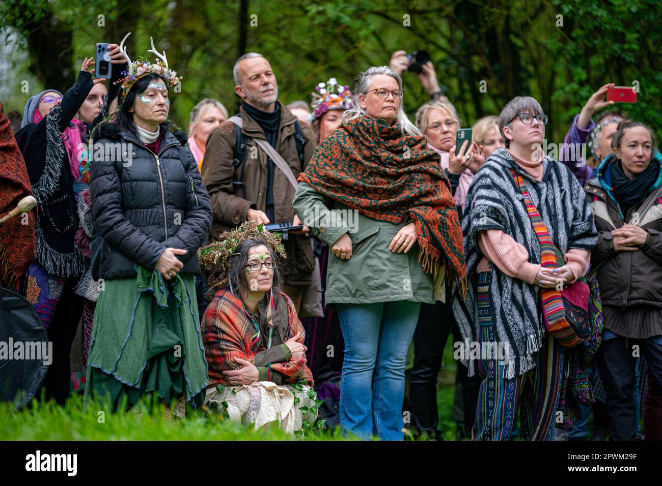 People watch the Beltane ceremony at Chalice Well, Glastonbury ...