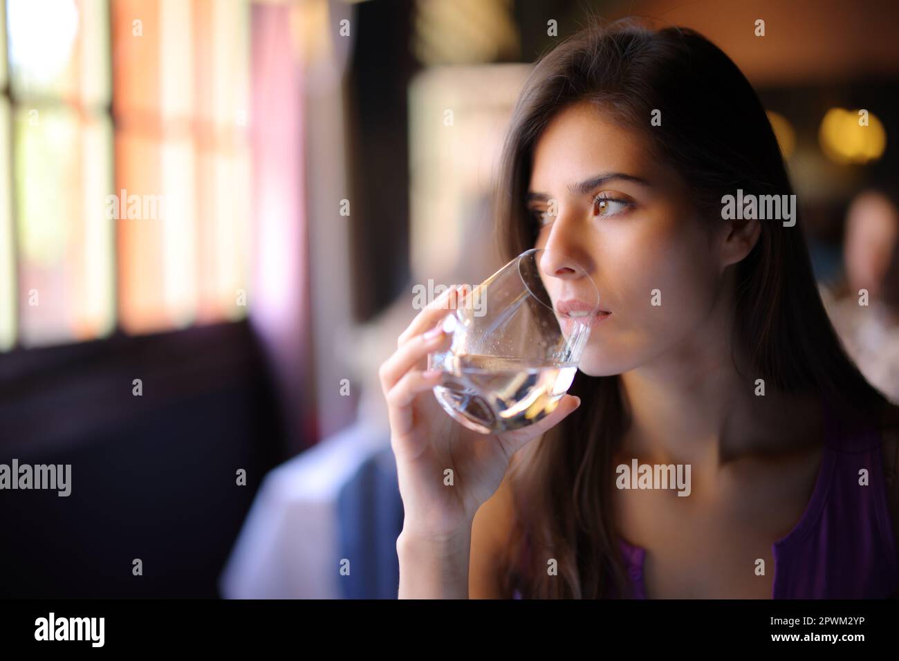 Woman looking through glass water hi-res stock photography and images - Alamy