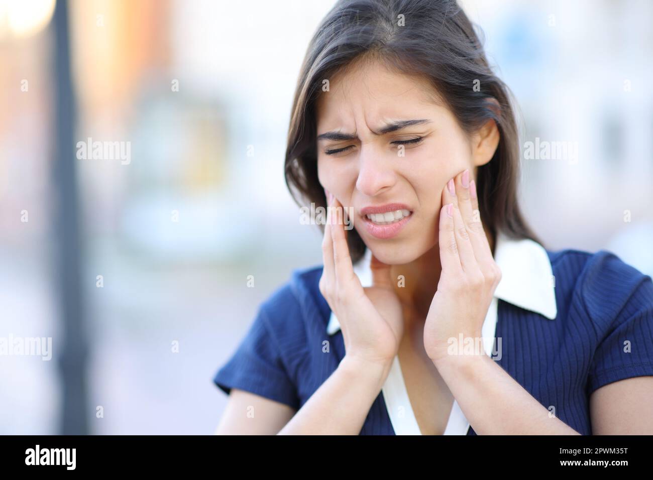 Stressed woman suffering tmj disorder complaining in the street Stock ...