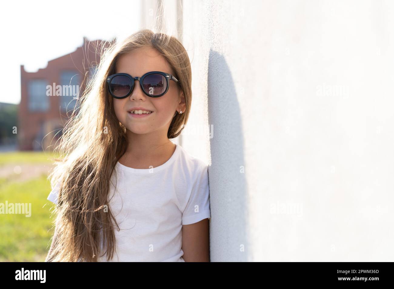 stylish girl child wearing bright clothes and sunglasses against the ...