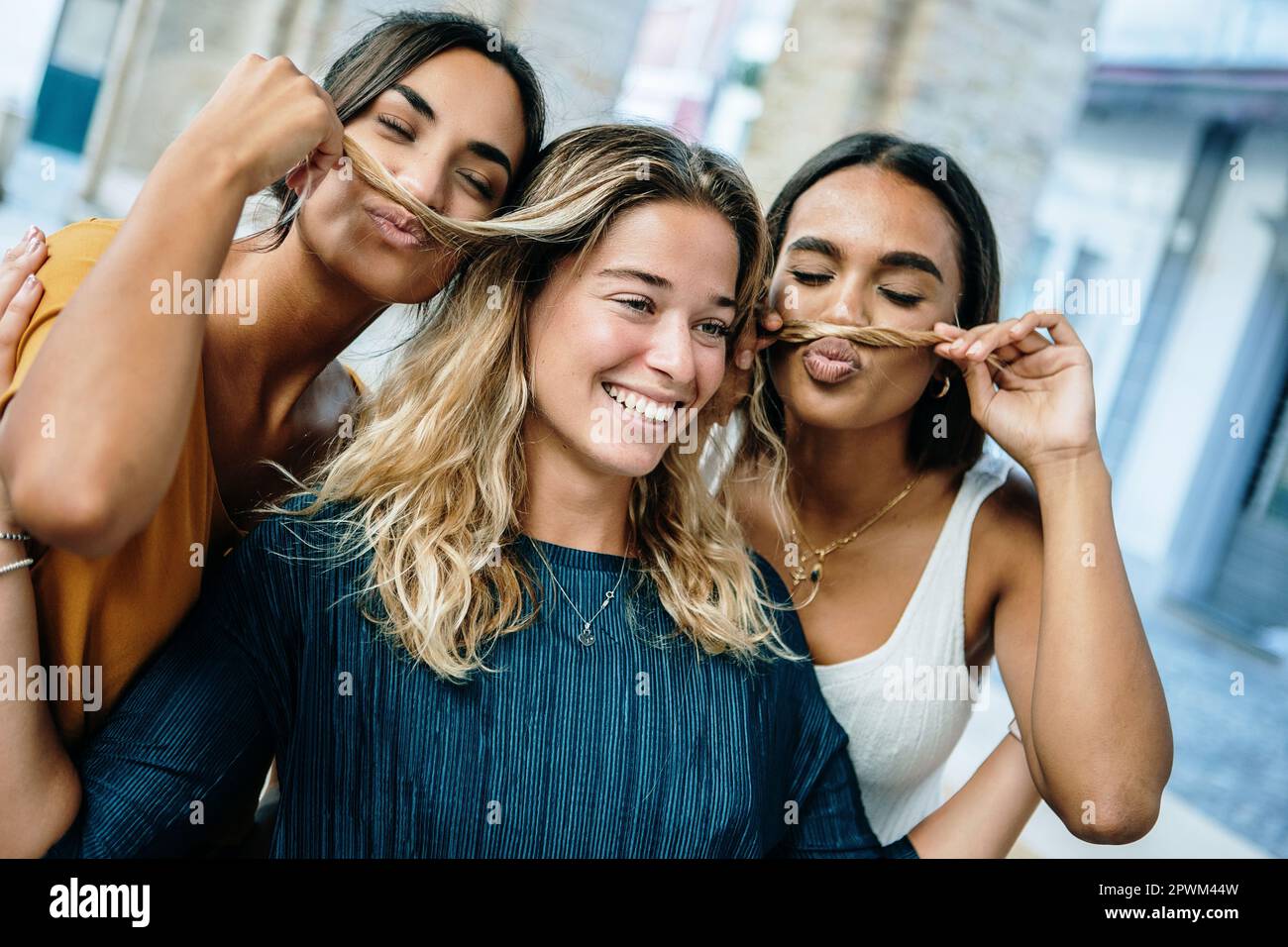 Three young women having fun taking photo together on summer vacation ...