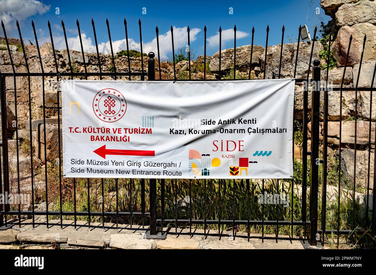 A printed sign offering directions to Side Museum in Antalya Province ...