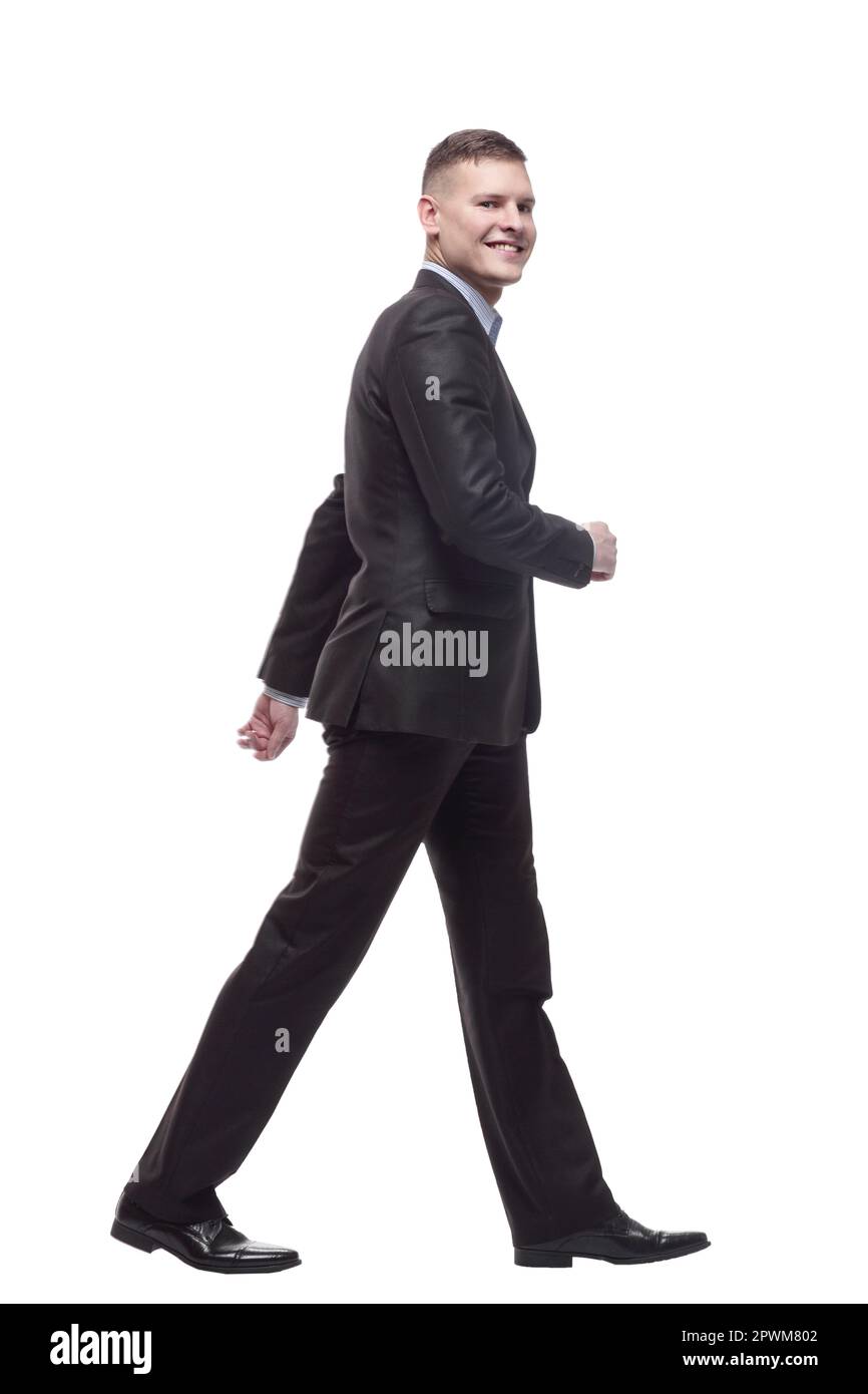 young businessman confidently striding forward. isolated on a white ...