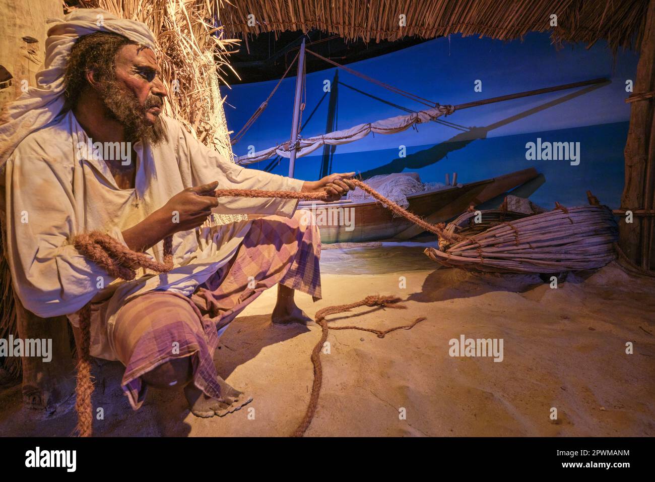 A fisherman pulling a rope line from his net, wood catch device on the ...
