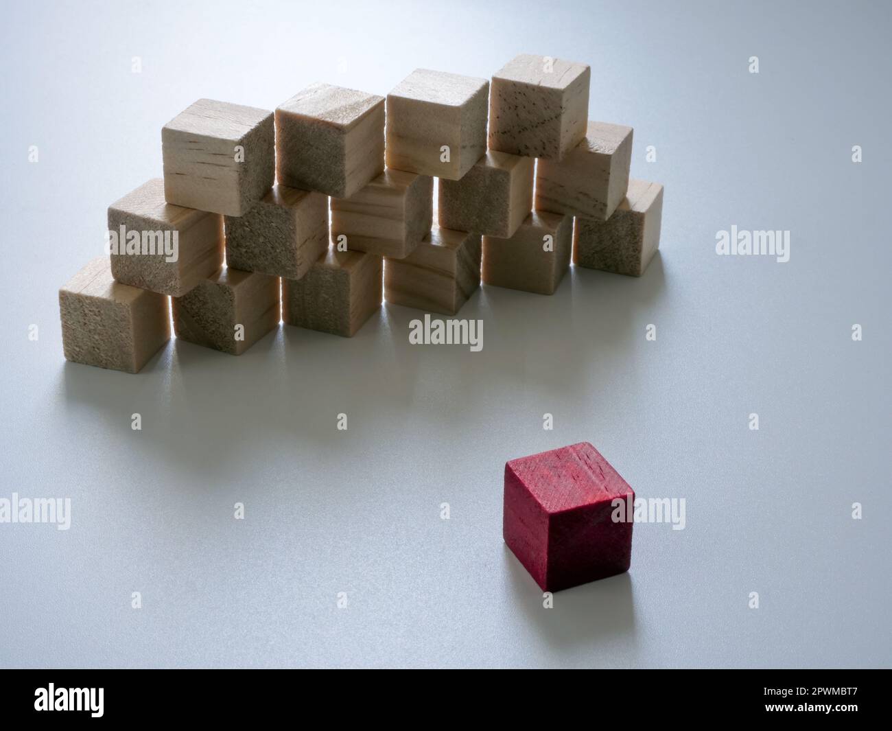 A wall of wooden cubes and in front of it is red. Overcoming ...