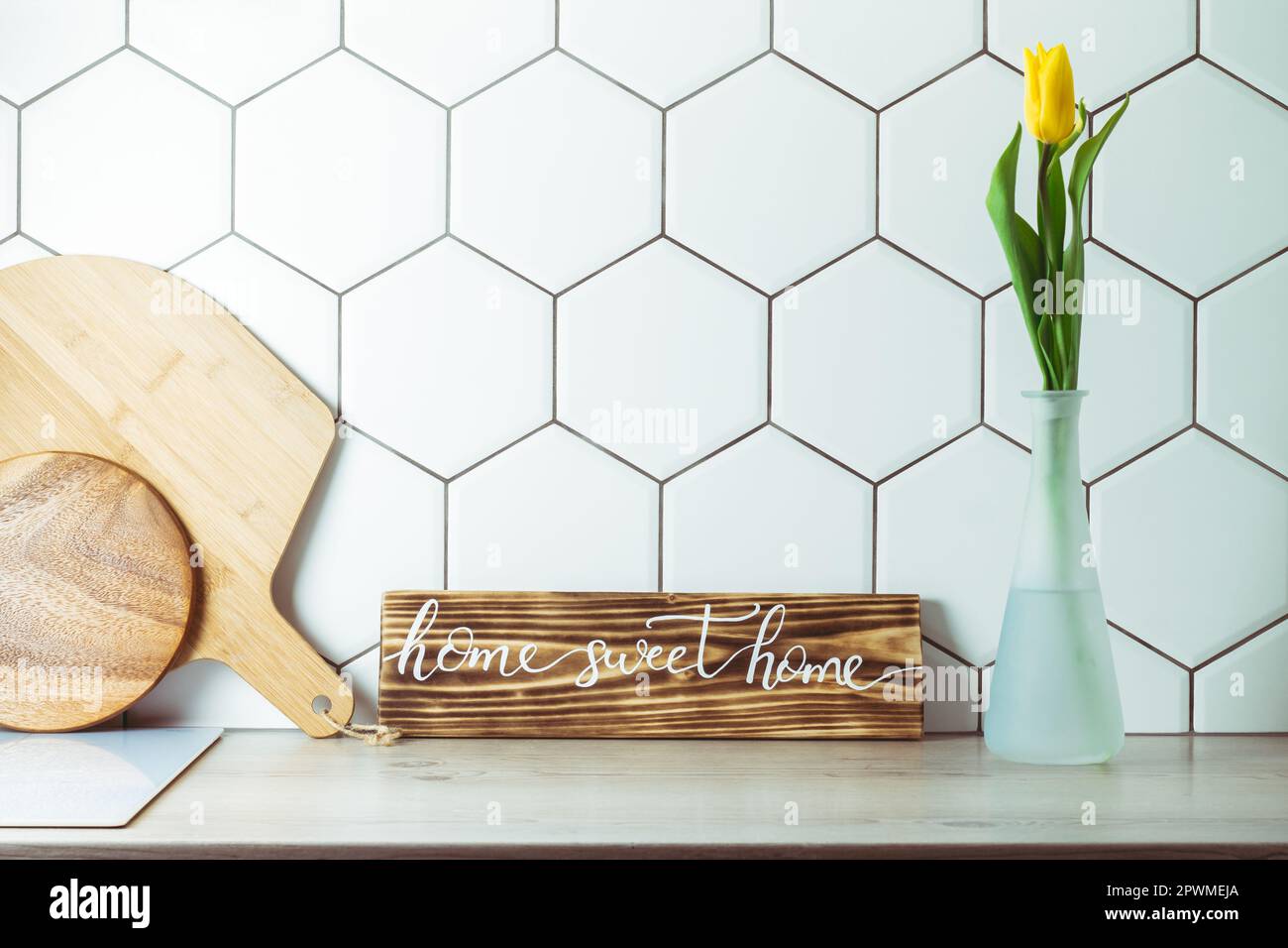 Interior shot. Home sweet home handwritten sign on kitchen countertop ...