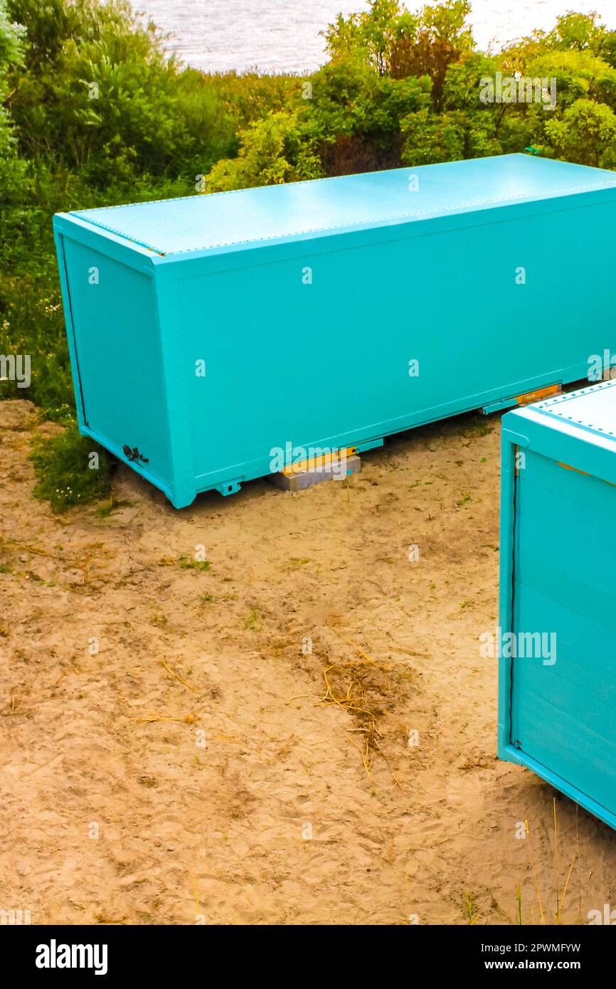 Turquoise shipping container parked in the forest on Langlütjen island ...