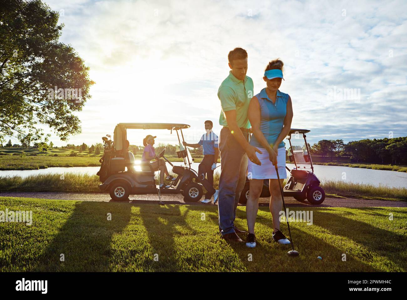 Youre a natural, babe. a husband helping his wife play golf Stock Photo ...