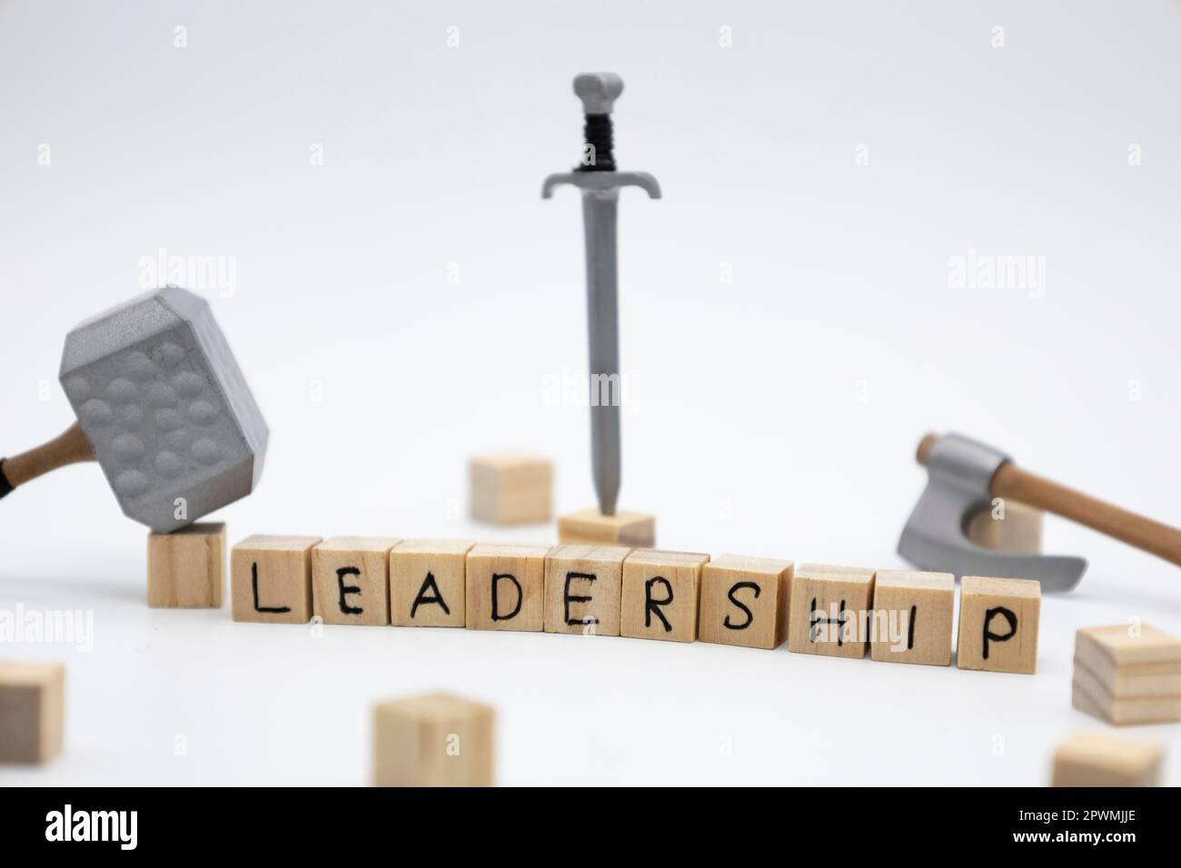 The wooden cubes with the word LEADERSHIP and the weapon around against ...