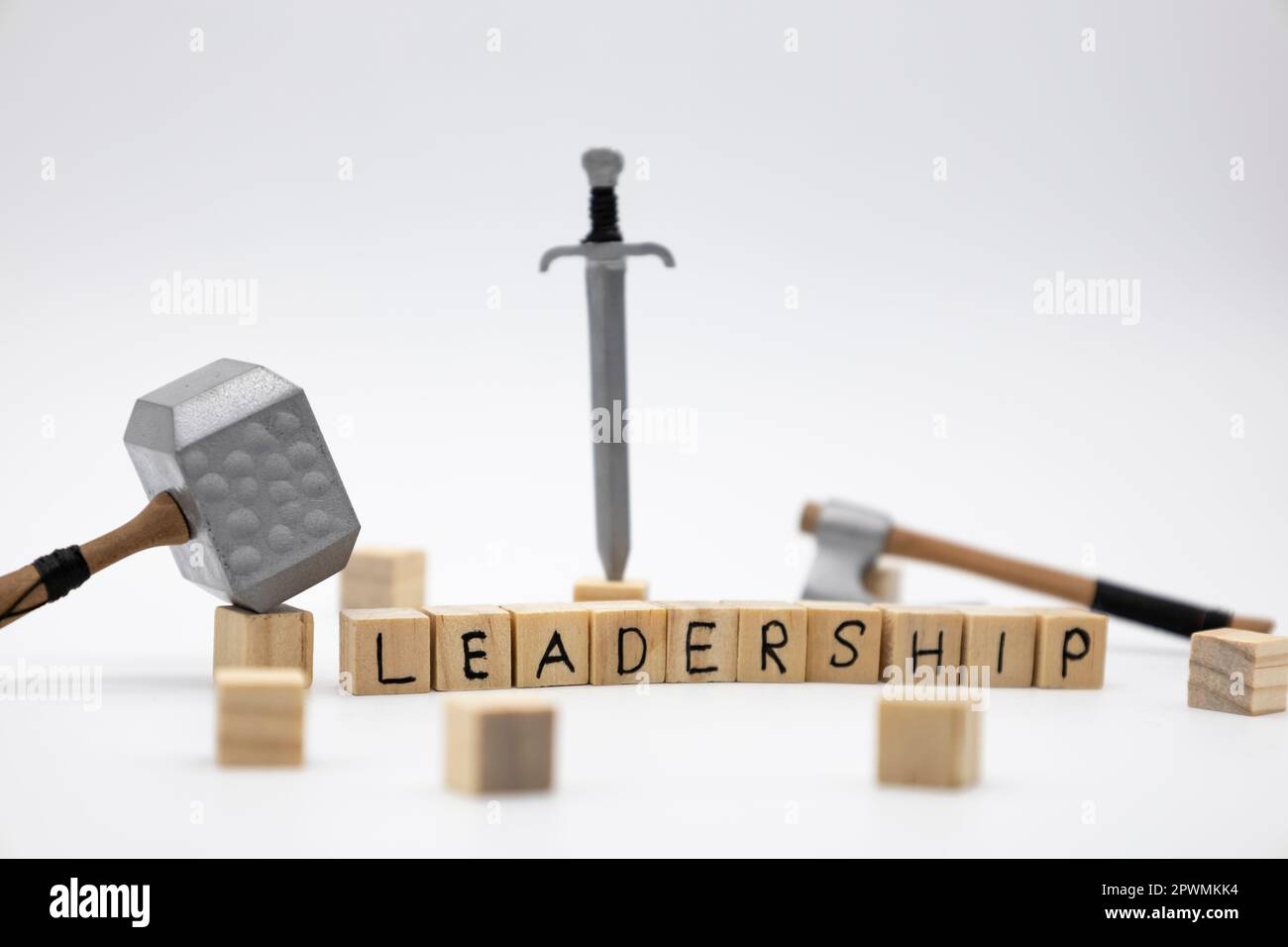 The wooden cubes with the word LEADERSHIP and the weapon around against ...