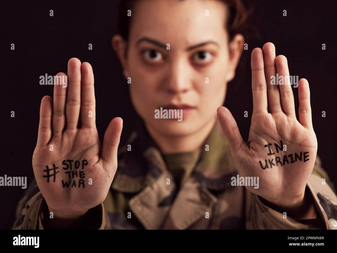 Ukraine, war and stop with woman soldier showing her hands or palms in ...
