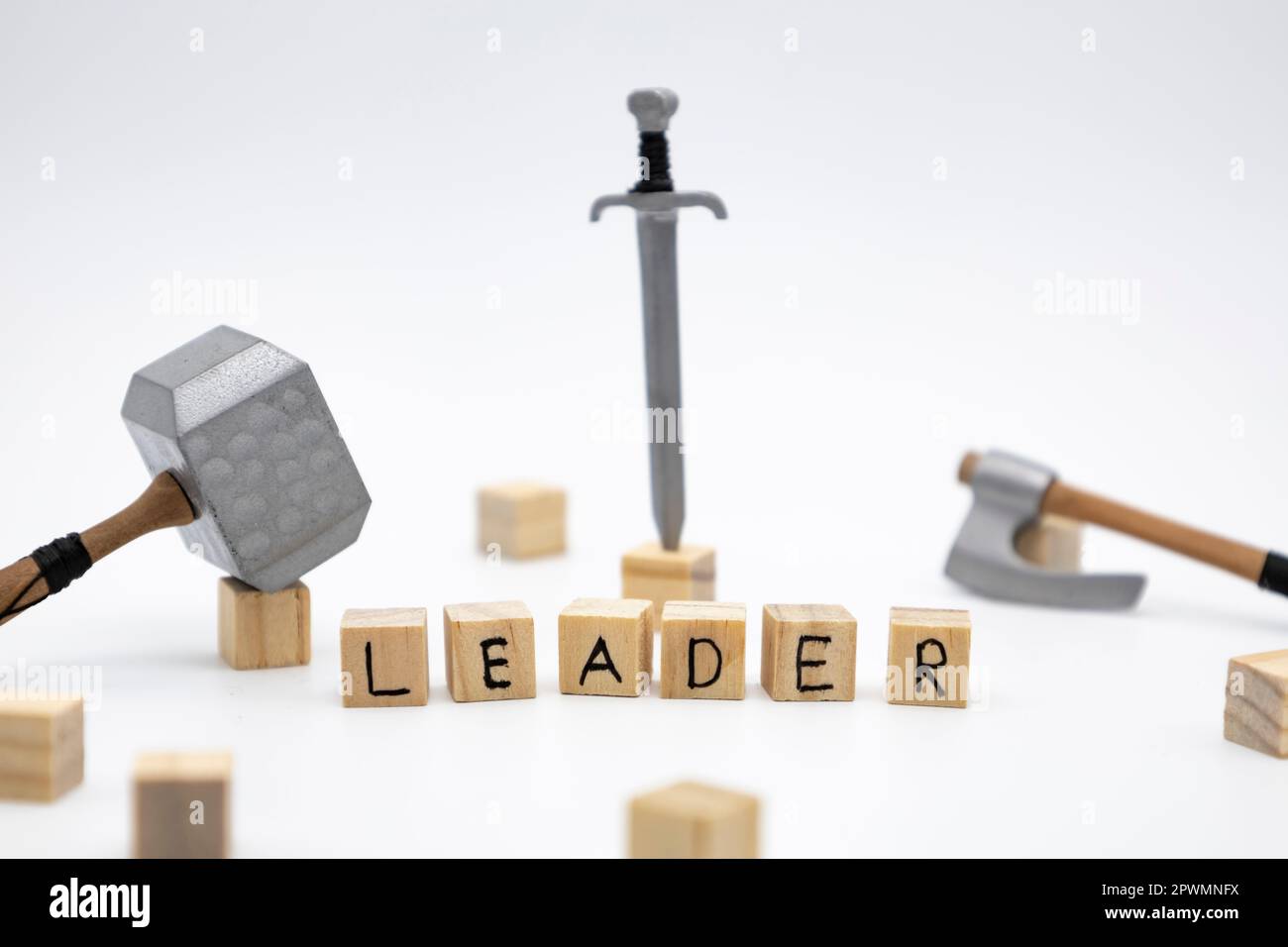 The wooden cubes with the word LEADER and the weapon around against ...