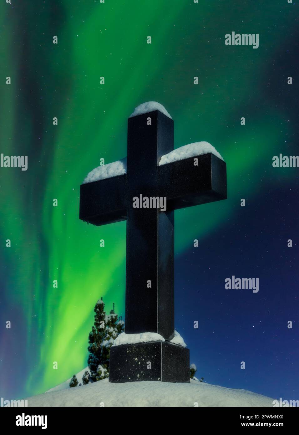 Polar lights and a snow covered historic crucifix in a cemetry Stock Photo - Alamy