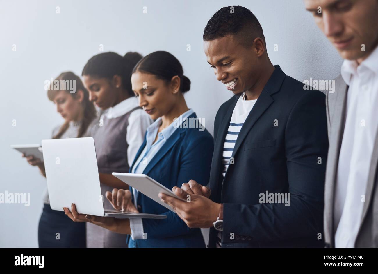 The final five candidates. a group of young businesspeople waiting in ...