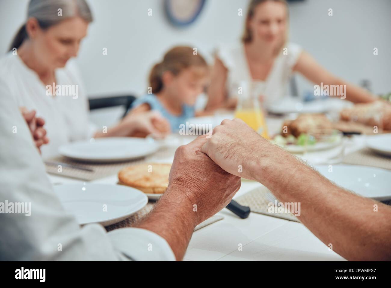 Big family, holding hands and pray before food with love, care and god ...