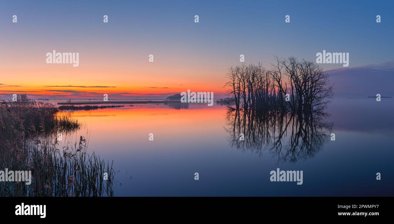 A spring morning with a layer of mist over the water and a beautiful ...