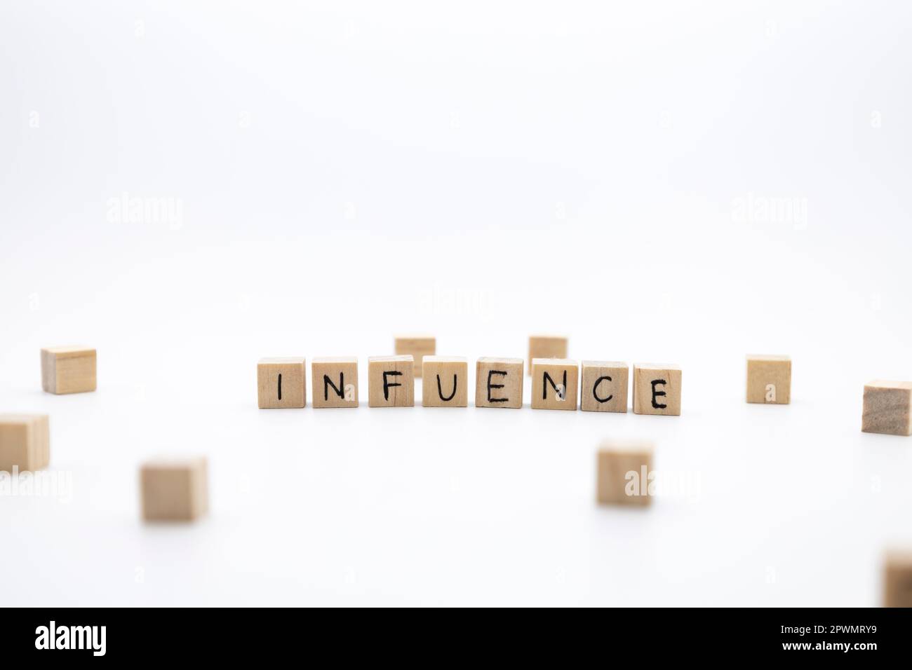 The wooden cubes with the word INFLUENCE against white background Stock ...