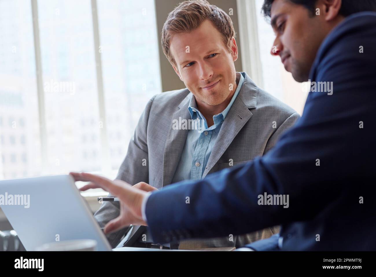 Leading the way with his ideas. businessmen working in their office ...