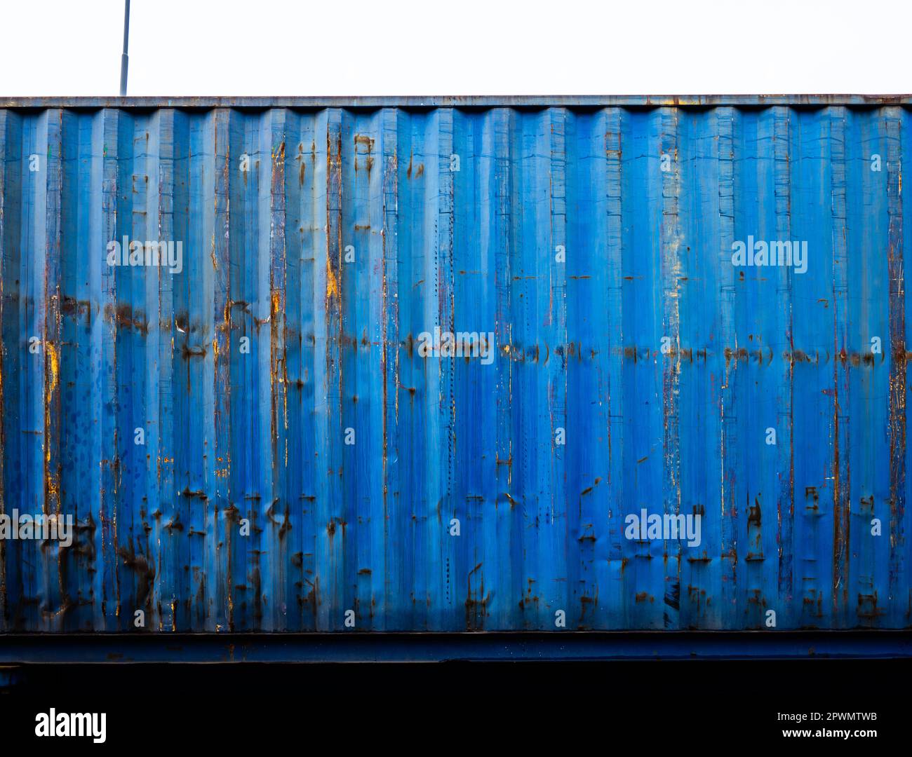 Side of a blue worn shipping container Stock Photo - Alamy
