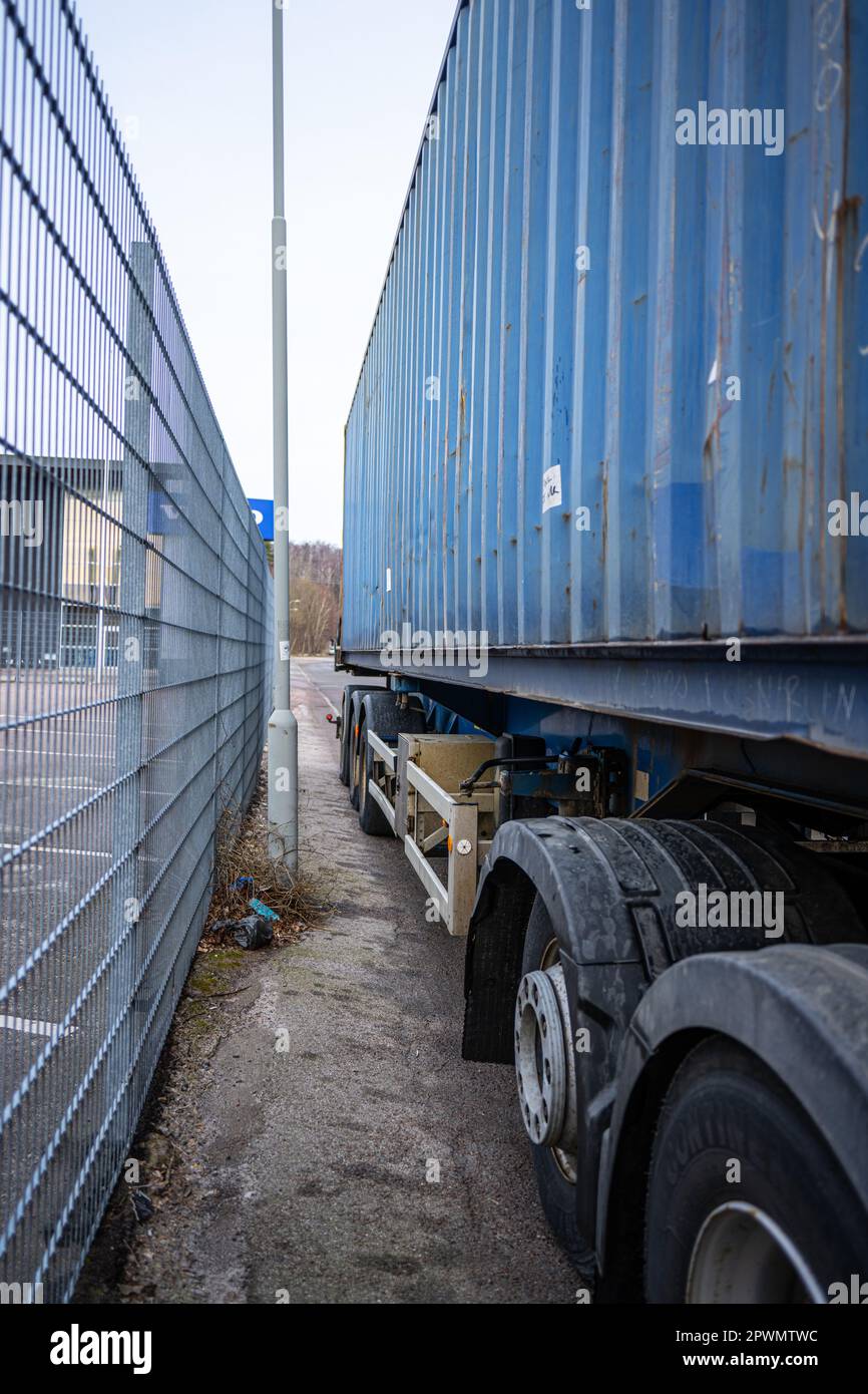 Trailer with freight container parked close to a fence and pole Stock ...