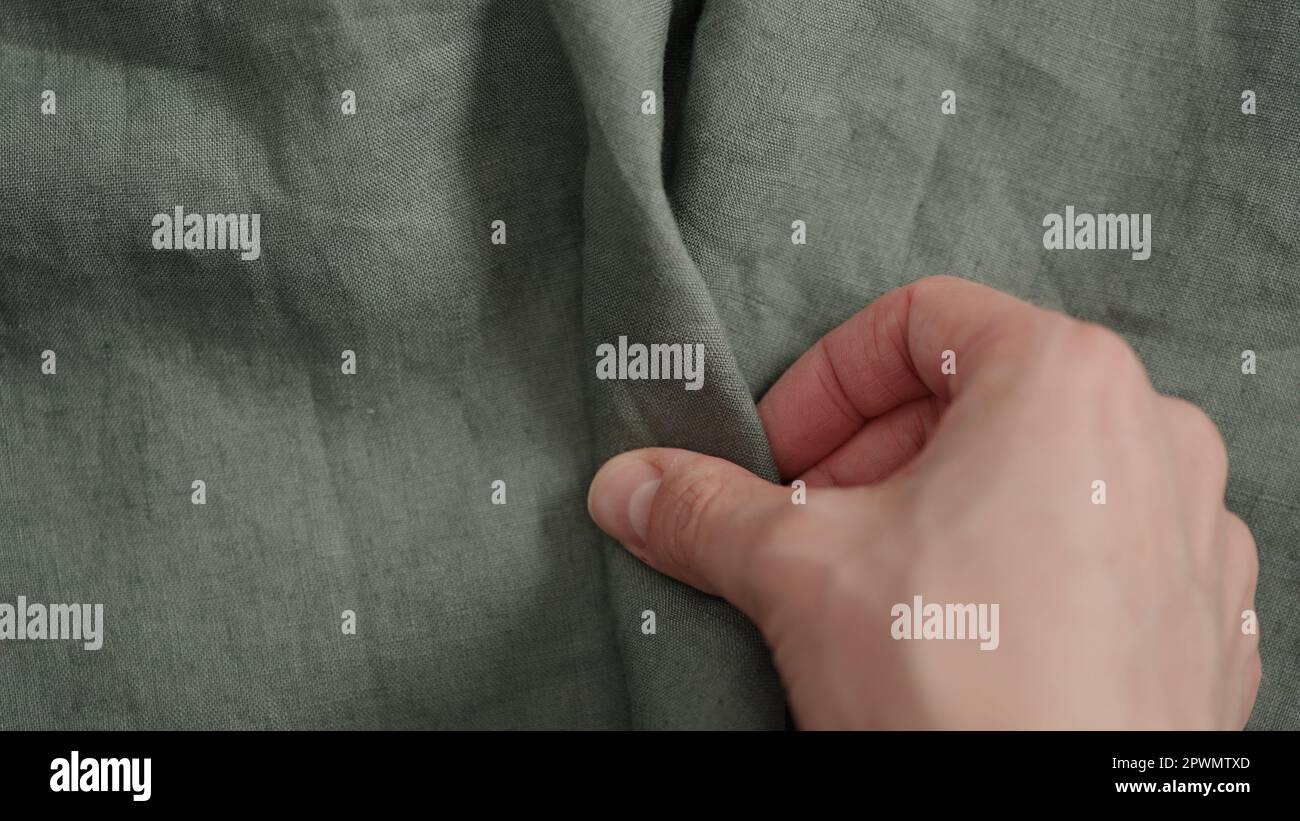 Man hand touching linen cloth, shallow focus Stock Photo - Alamy
