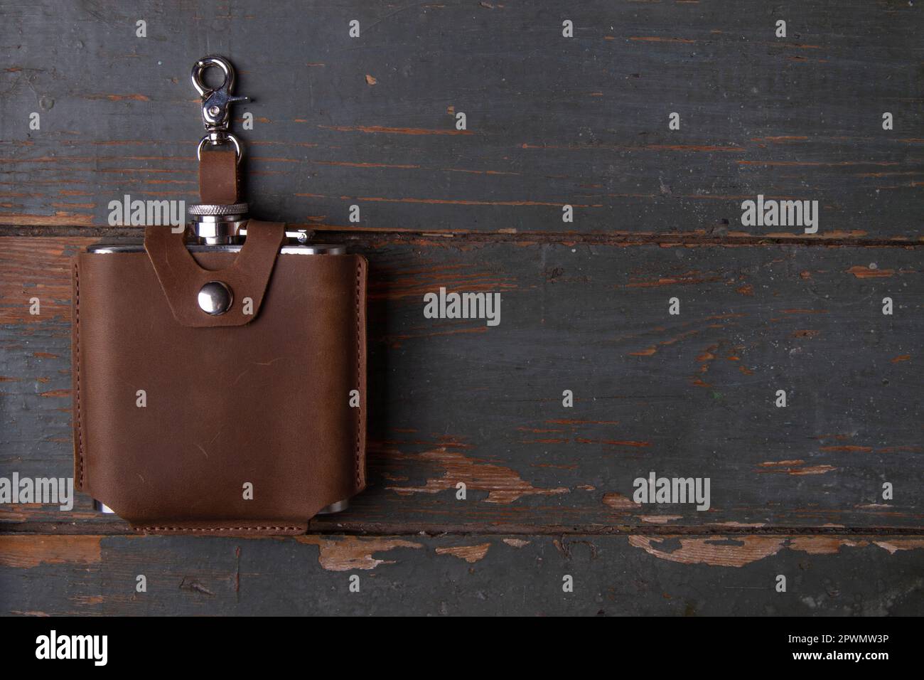 Hip flask in full grain leather Hip flask case on wooden table. Banner ...