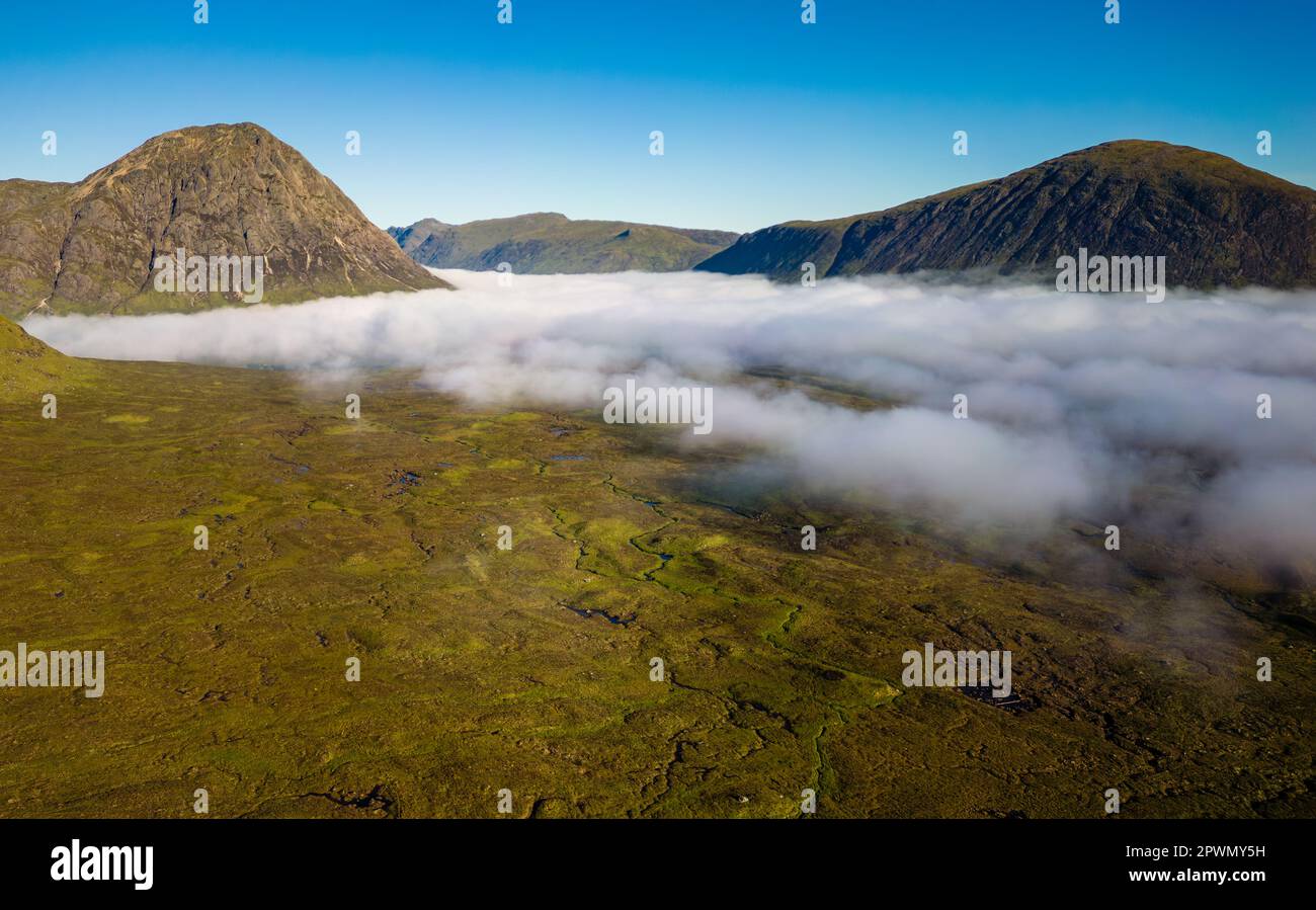 Aerial view of low cloud and fog in a valley just after dawn (Glencoe ...