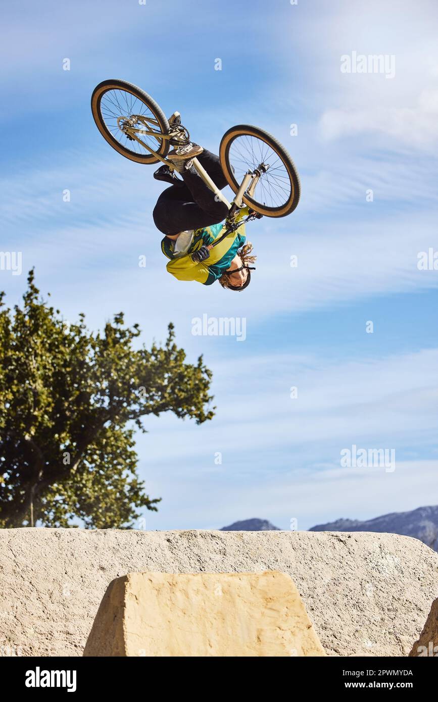 Cycling sports, bike and jump of man performing stunt outdoors in ...