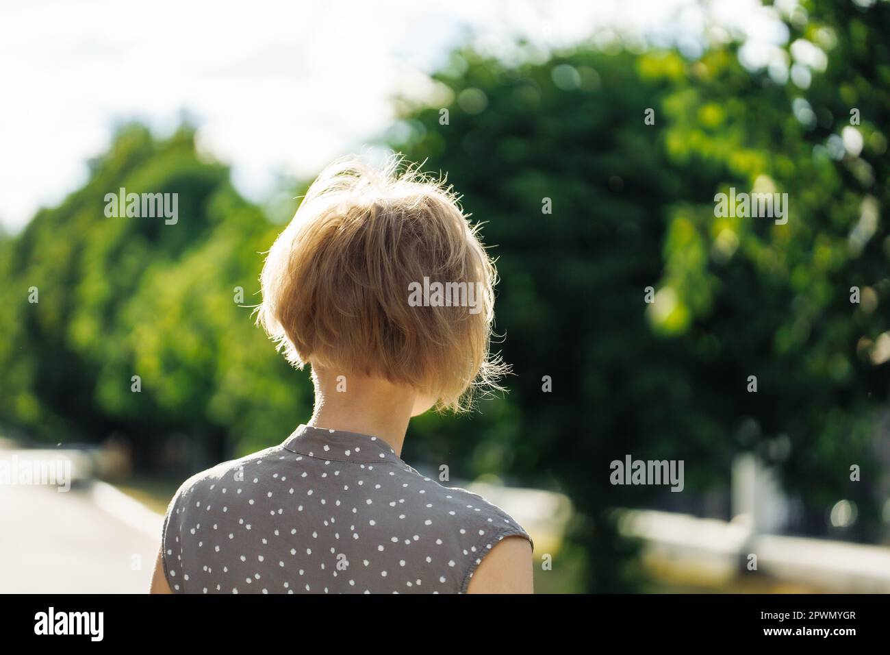 Woman back turned walking alone hi-res stock photography and images - Alamy