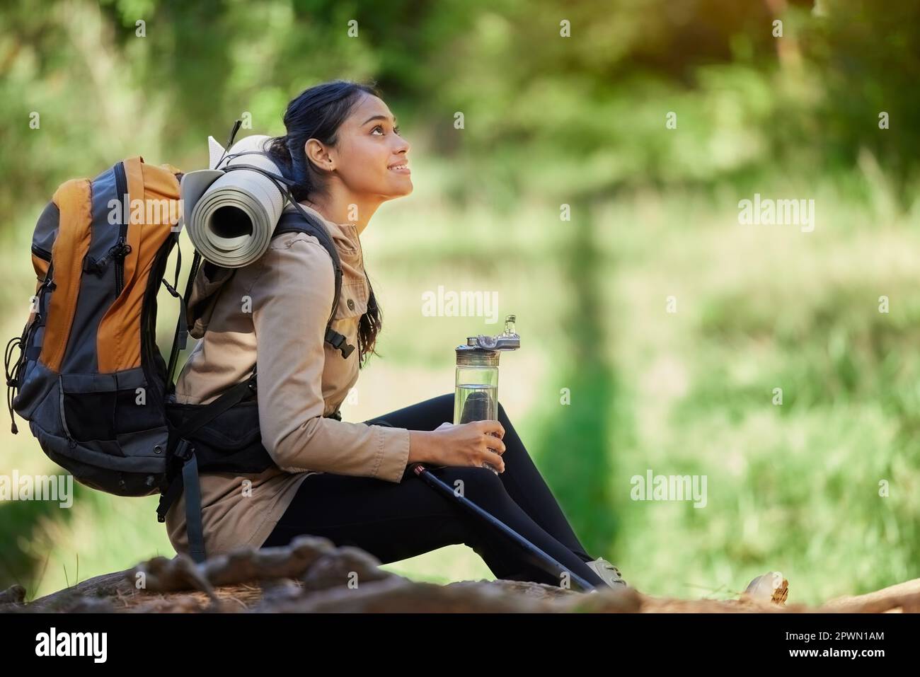 Black woman, hiking and rest sitting in nature, woods or forest for ...