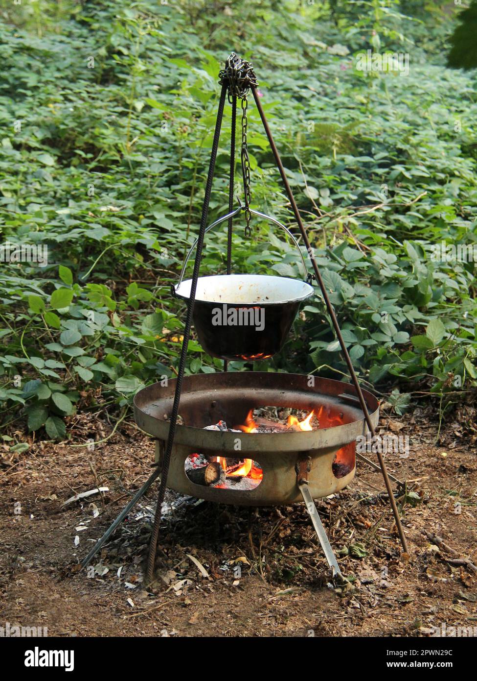 A Cooking Pot on a Tripod Over an Outdoor Wood Fire Stock Photo - Alamy