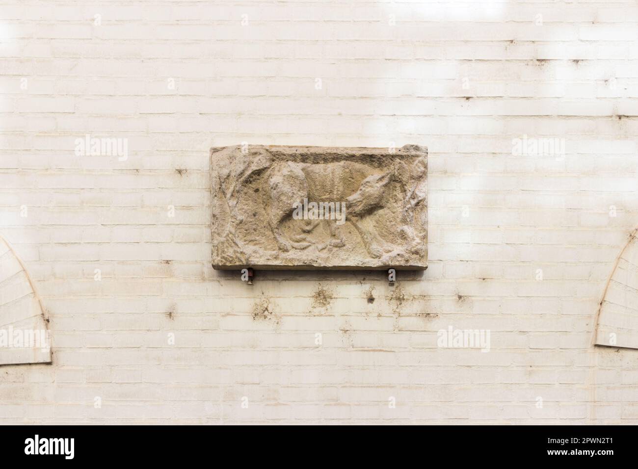 Ancient Roman stone relief of wolf feeding Romulus and Remus on wall ...