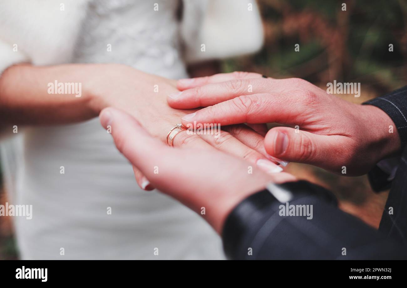 Marry me today. hands of a wedding couple. Groom put a ring on finger ...