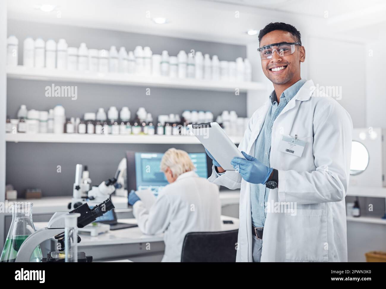 Science, tablet and portrait of a male scientist doing research with ...