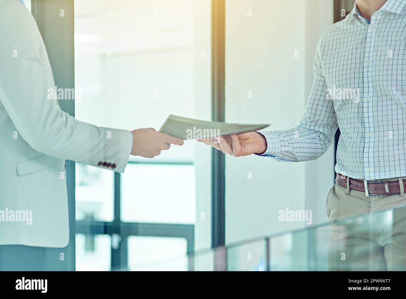 Doing a handover. a businessman handing a document to a colleague Stock ...