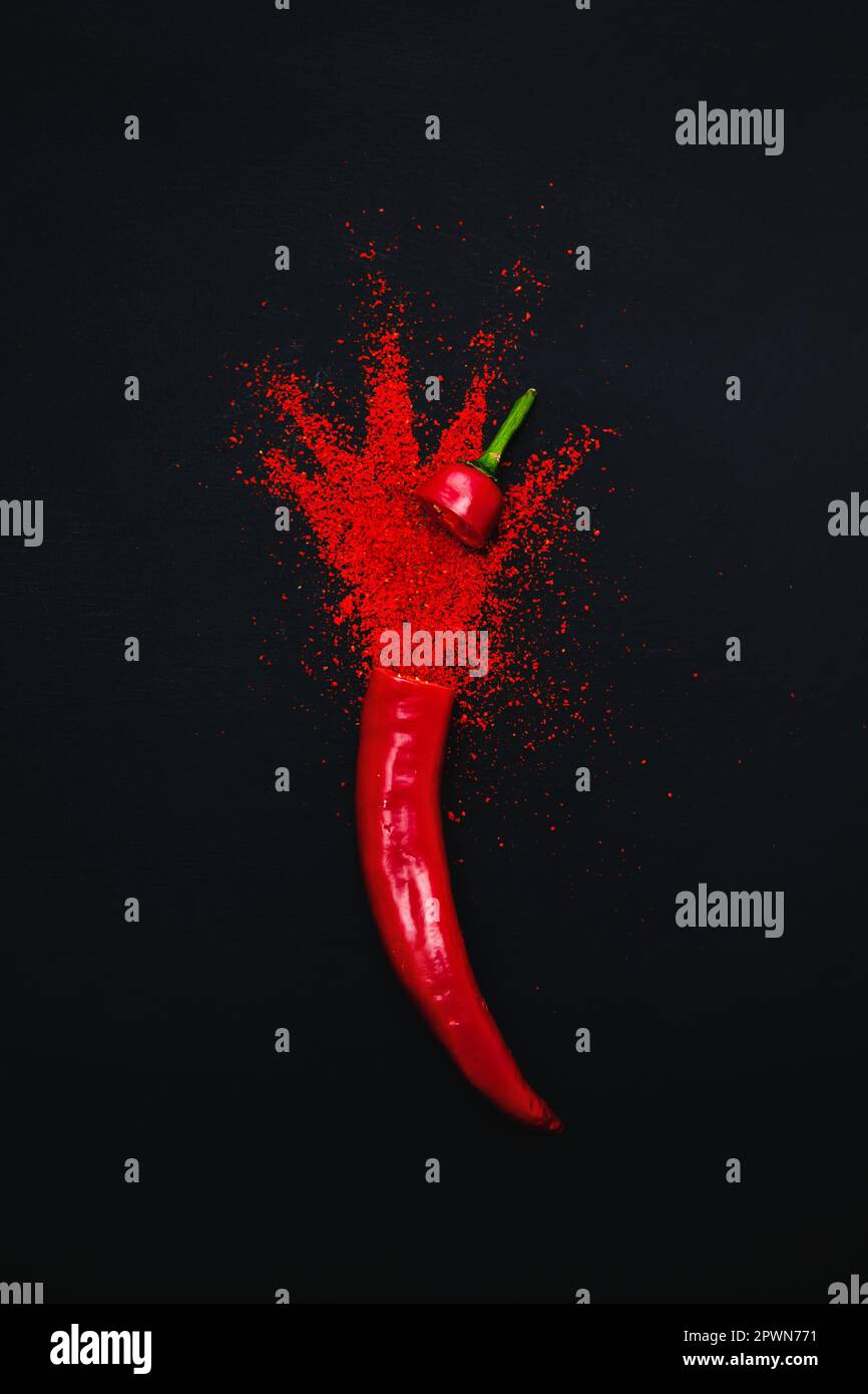 Exploding pepper. Chili pepper turns into powder. Dark background Stock ...