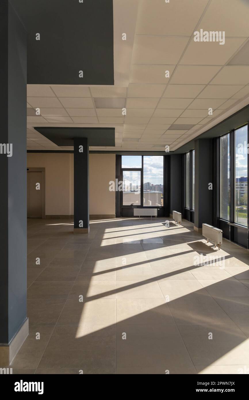 A large, spacious, empty room with huge windows and floor-mounted ...