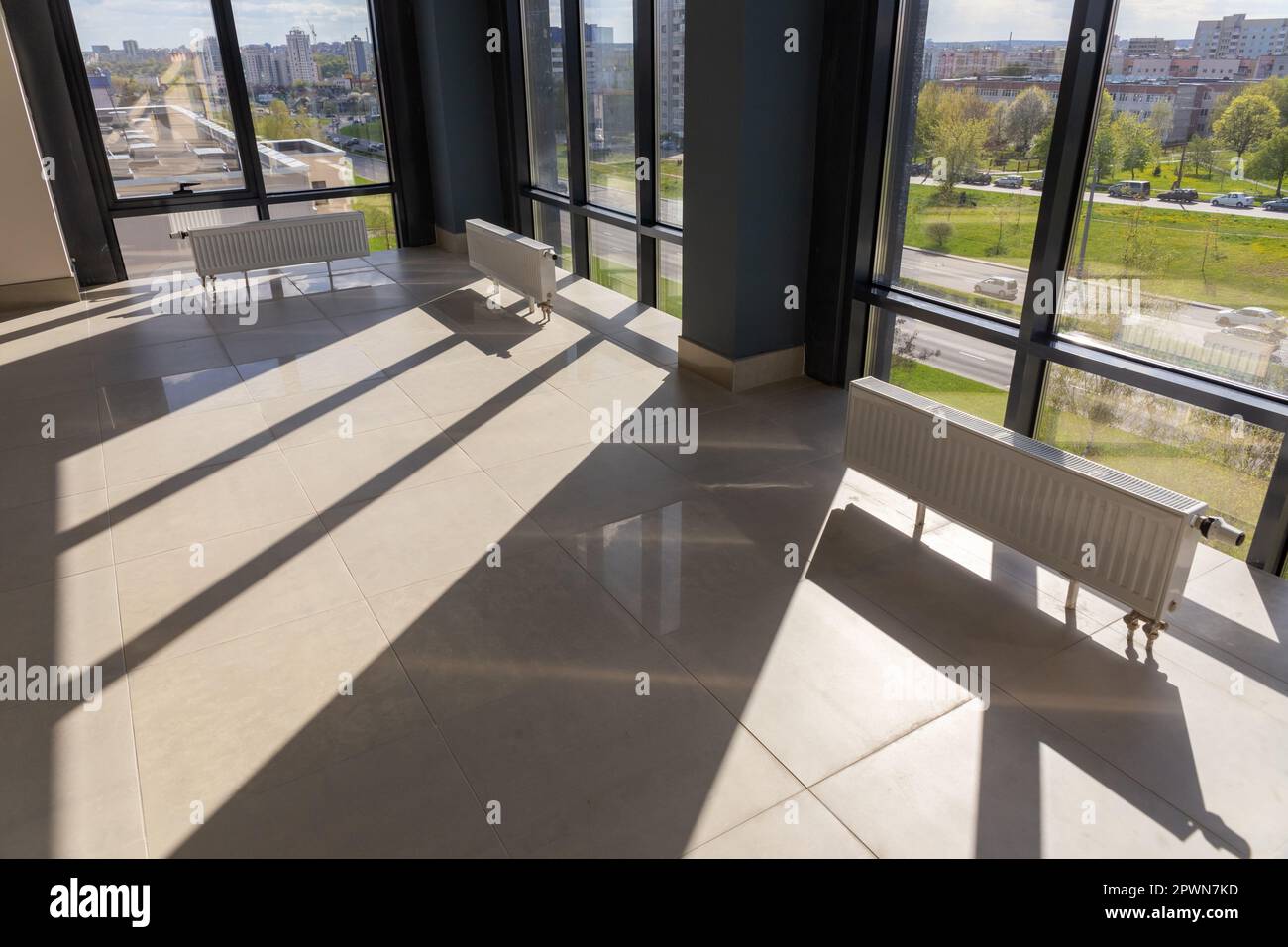 A large, spacious, empty room with huge windows and floor-mounted ...